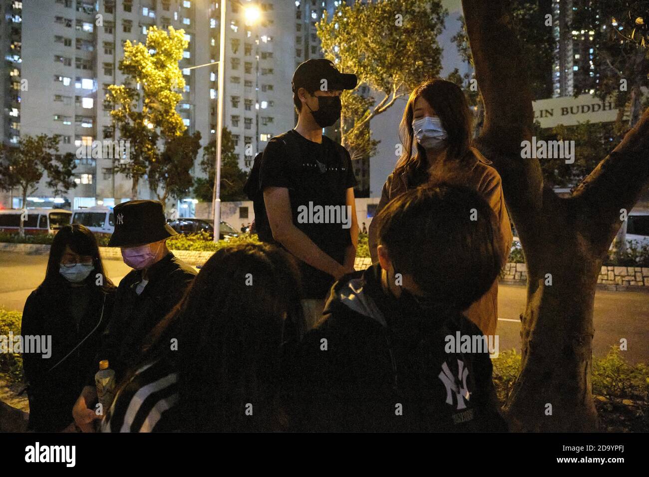 Mourners wearing face masks pay tribute to Alex Chow Tsz-lok.Mourners ...