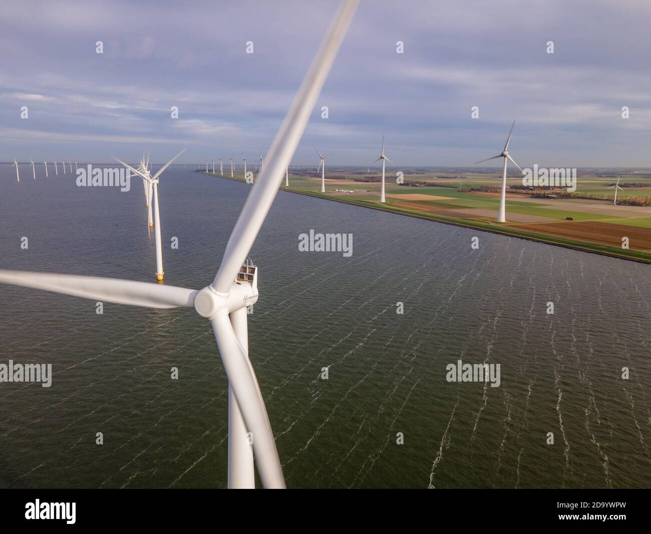 offshore windmill park with clouds and a blue sky, windmill park in the ocean drone aerial view ...