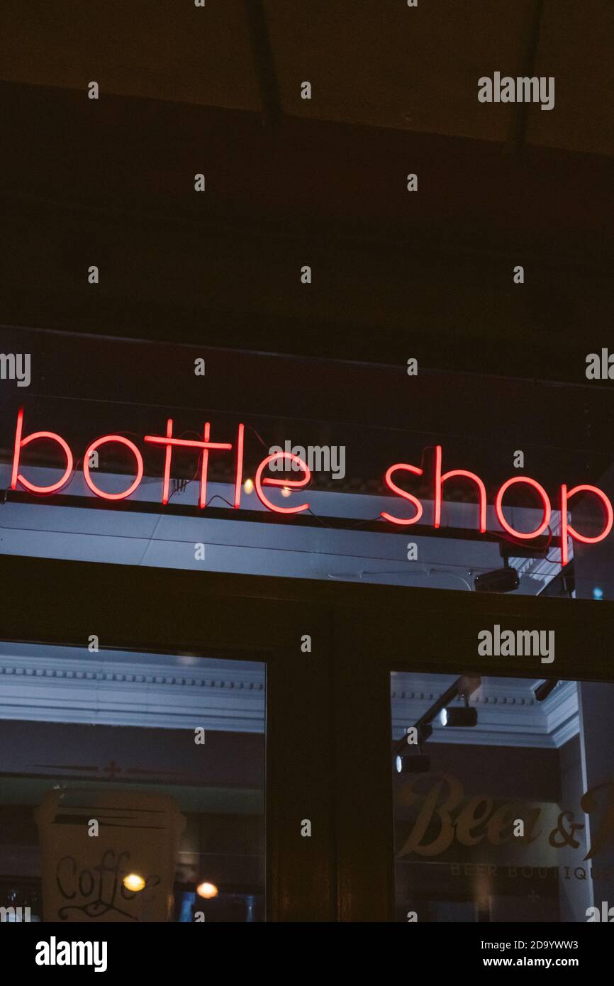 neon sign bottle shop bar wine beer sale showcase Stock Photo - Alamy