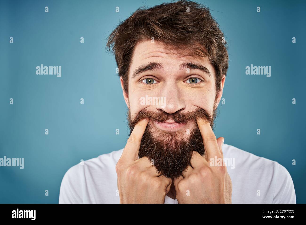 Bearded man displeased facial expression emotions close-up blue ...