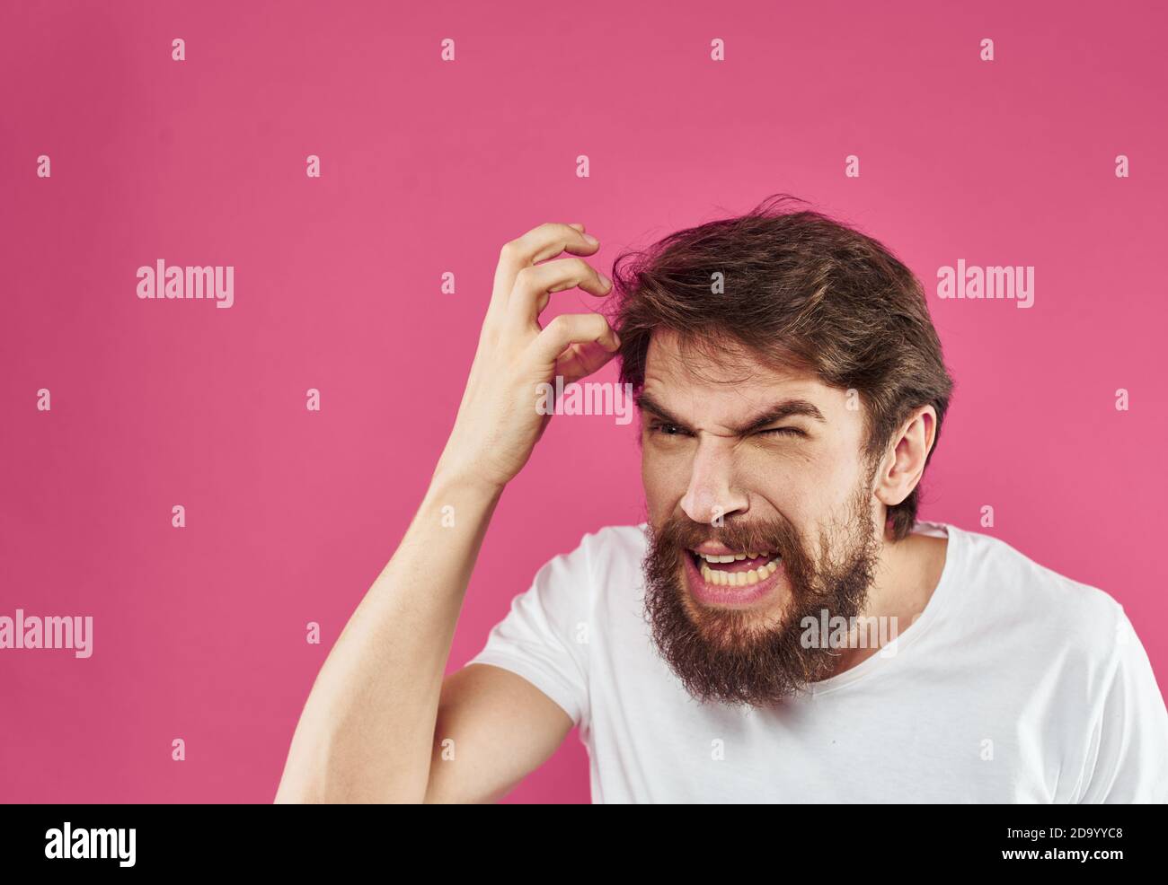 angry man with beard holds hands near face and stress irritability ...