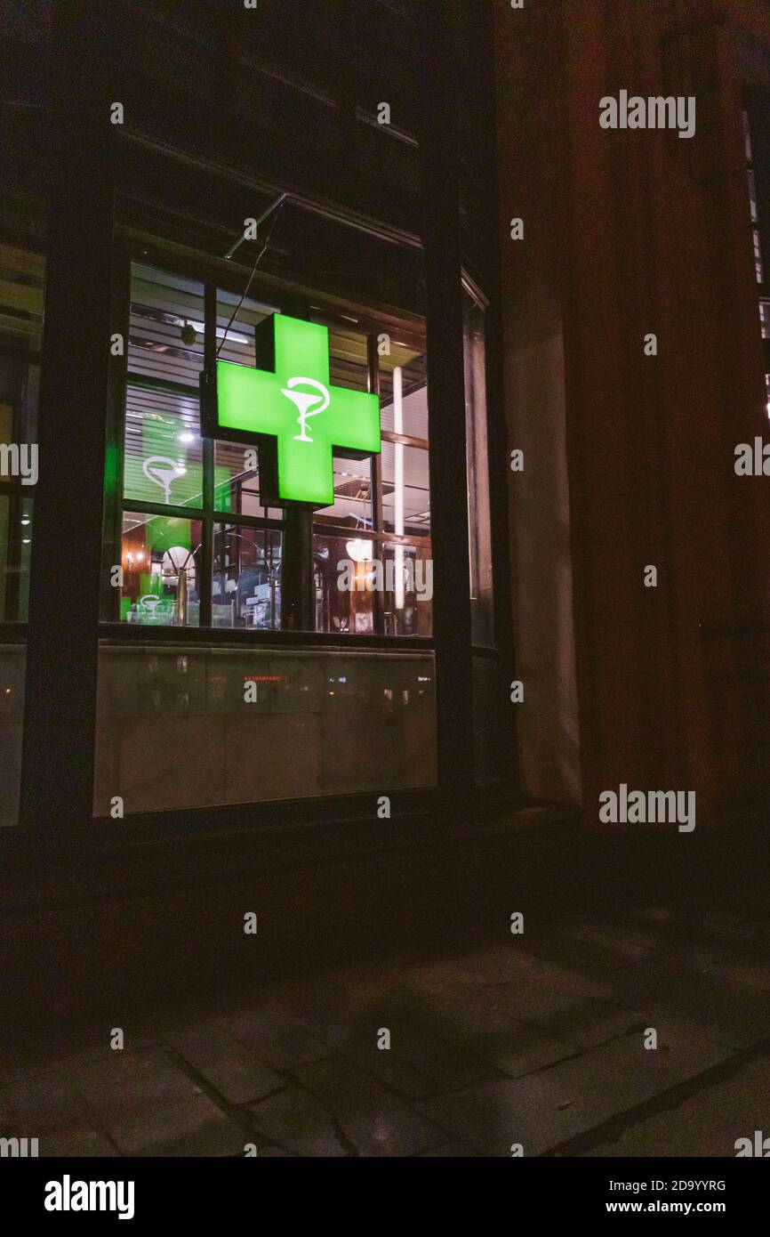 pharmacy cross with snake 24 hours first aid night Stock Photo - Alamy