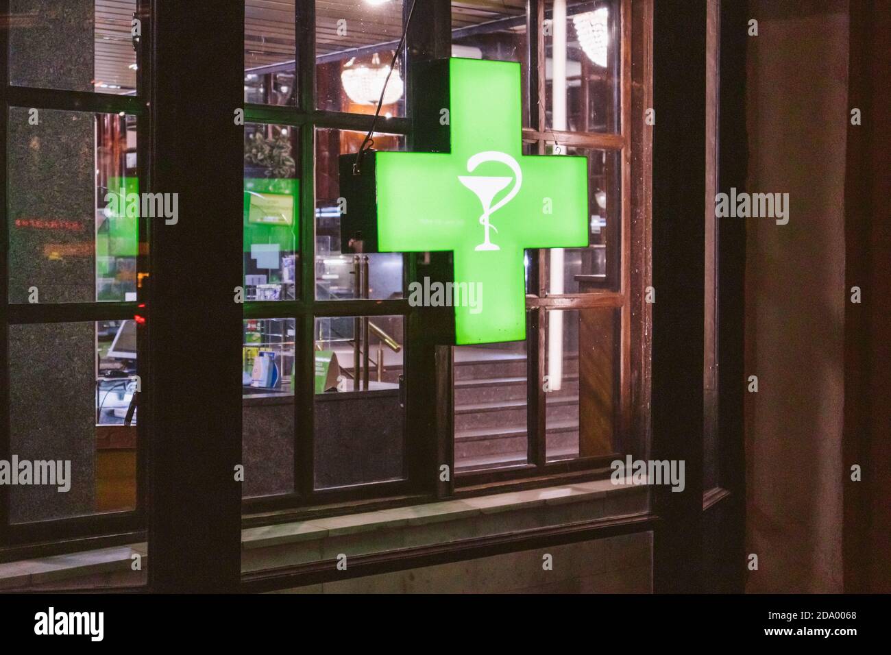 pharmacy cross with snake 24 hours first aid night Stock Photo - Alamy