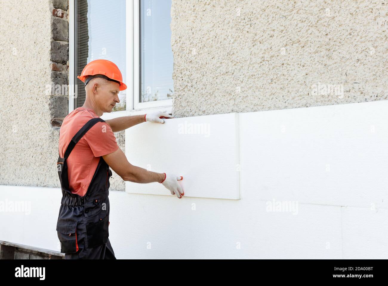 Insulation of the house with polyfoam. The worker is installing a ...