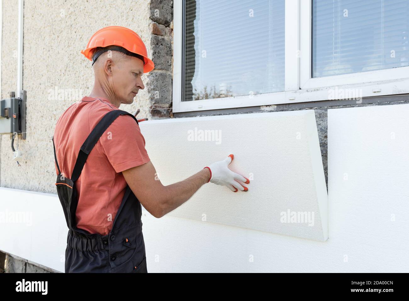 Insulation of the house with polyfoam. The worker is installing a ...
