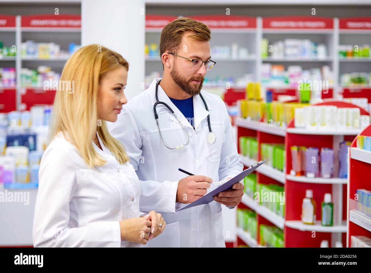 two apothecary man and woman talking, discussing medications ...