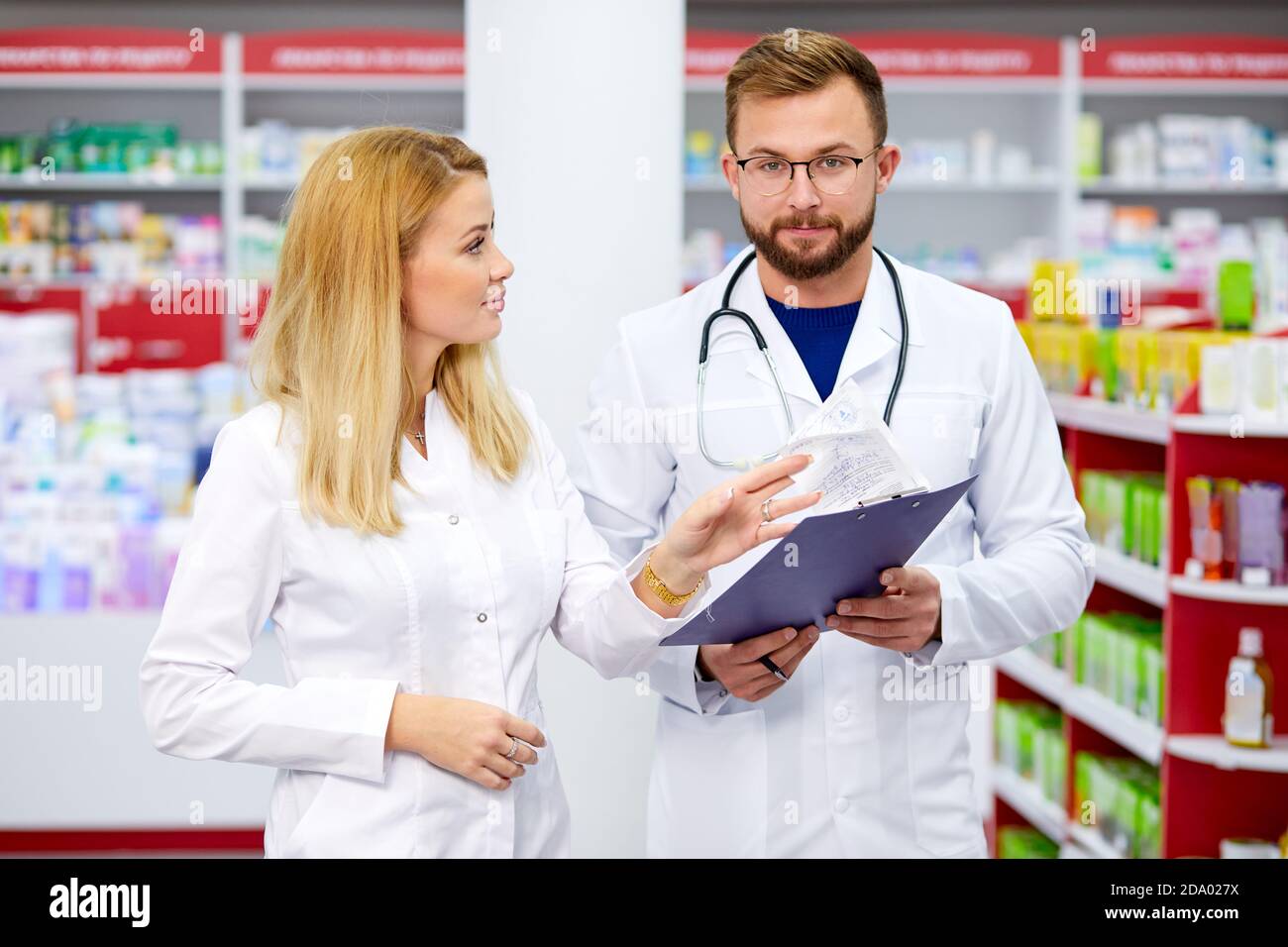 two apothecary man and woman talking, discussing medications ...