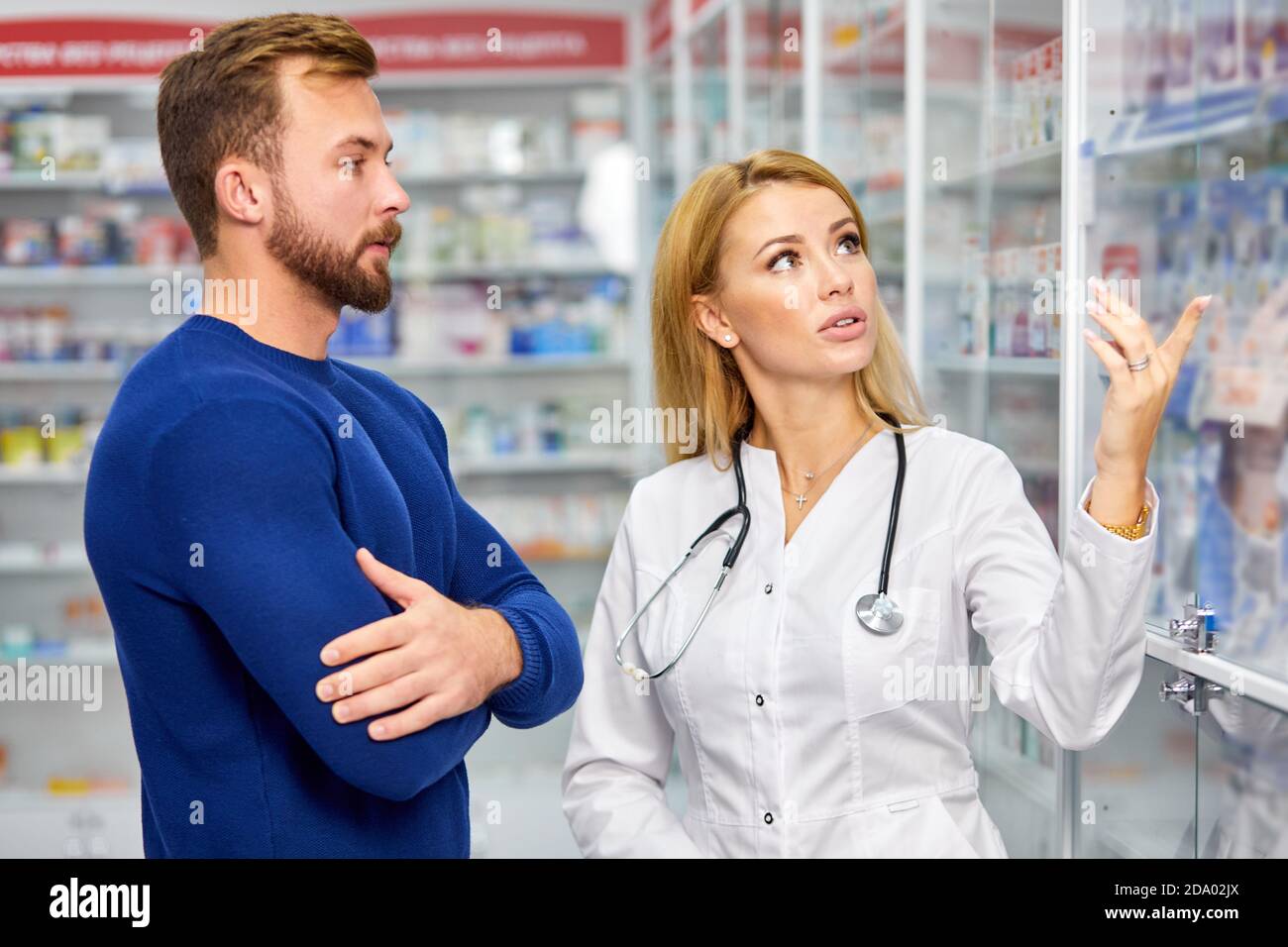 caucasian friendly pharmacist has a nice conversation with a client ...