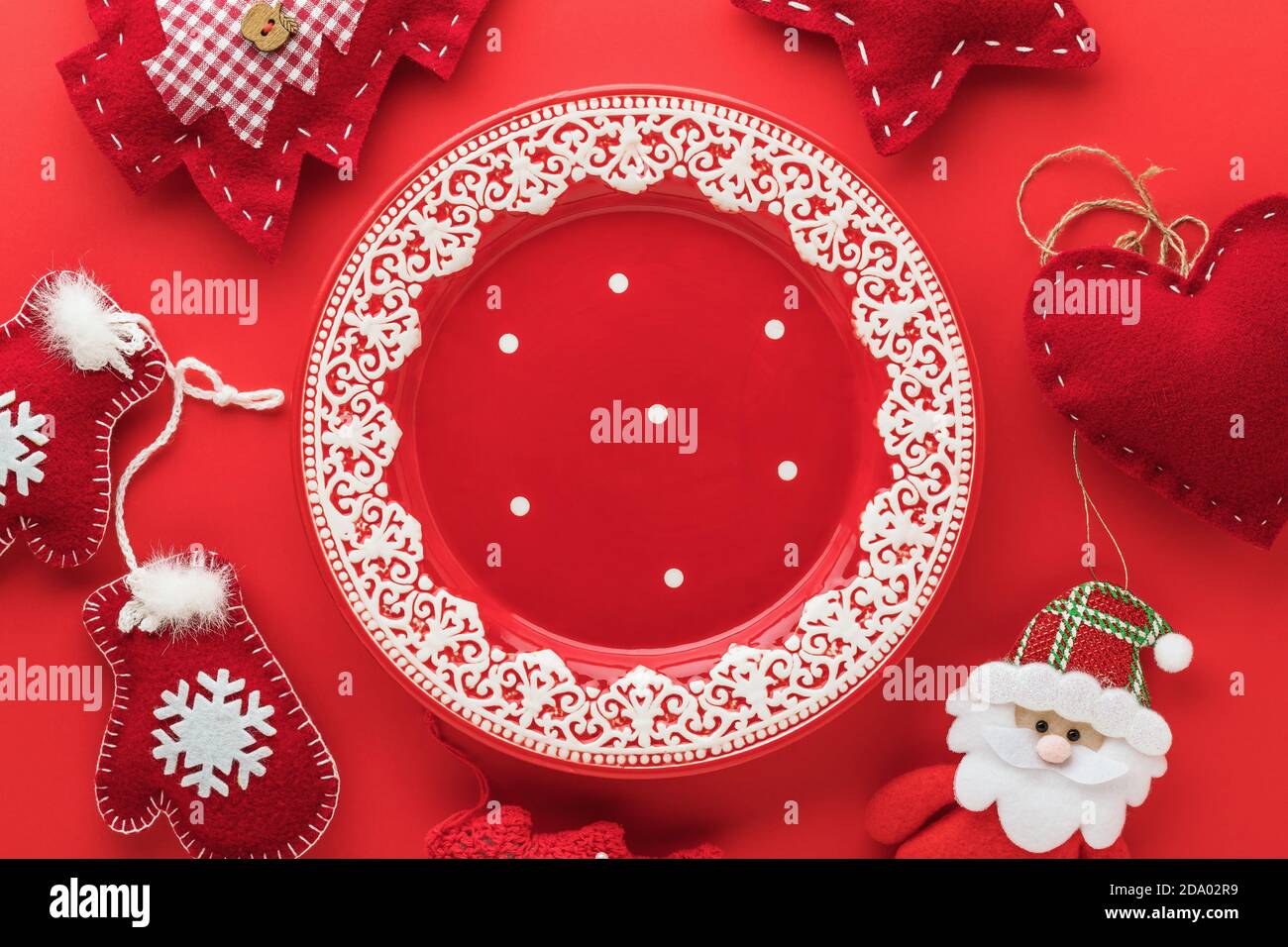 Empty plate and christmas toys on a red background, top view. Food ...