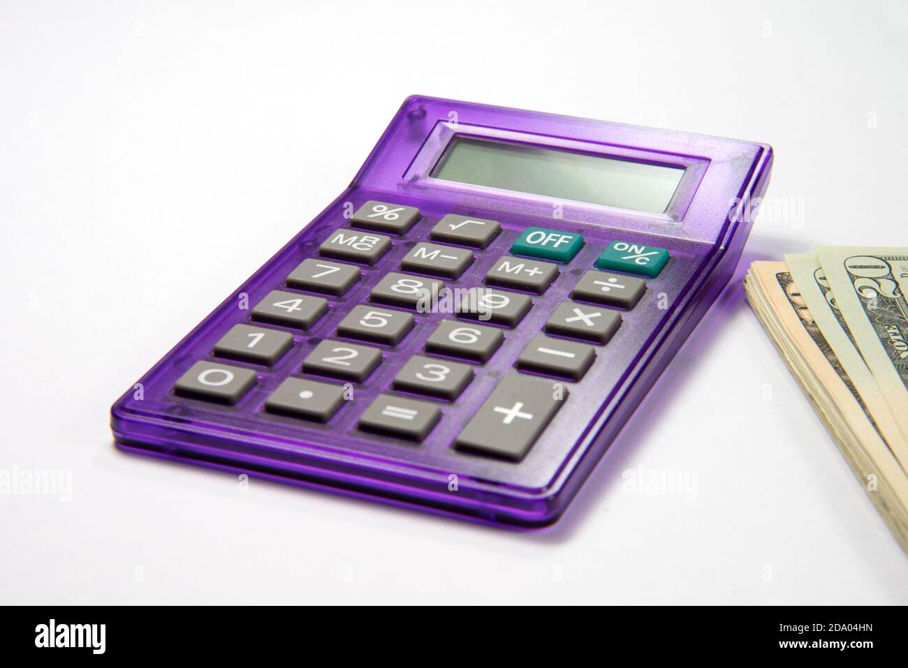 A calculator and dollar bills Stock Photo - Alamy