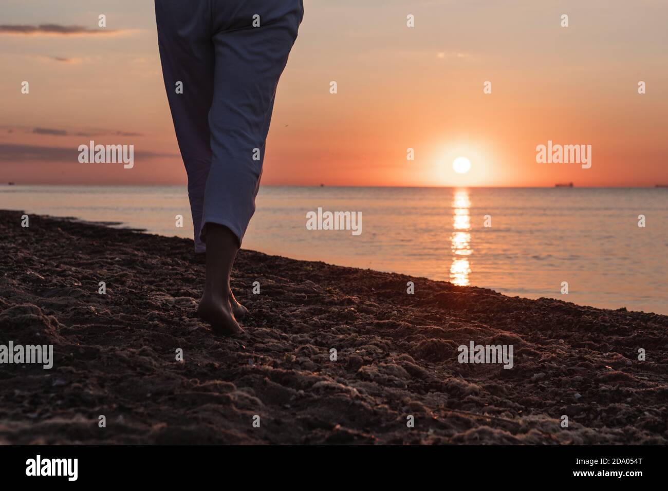 woman legs close up walking by sandy beach. sunset above the sea Stock ...
