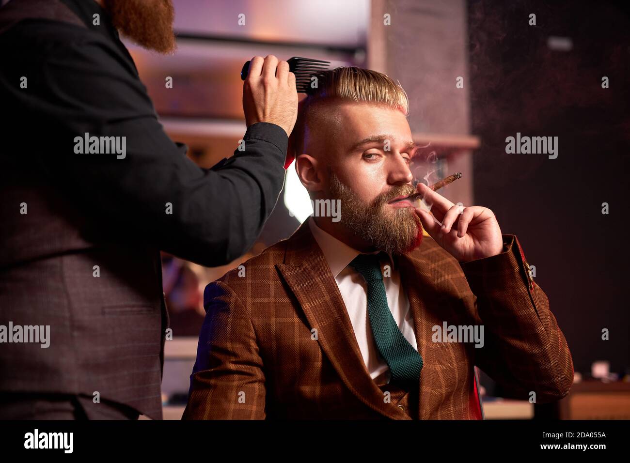stylish male enjoy haircut at the hairdresser, he is smoking during ...