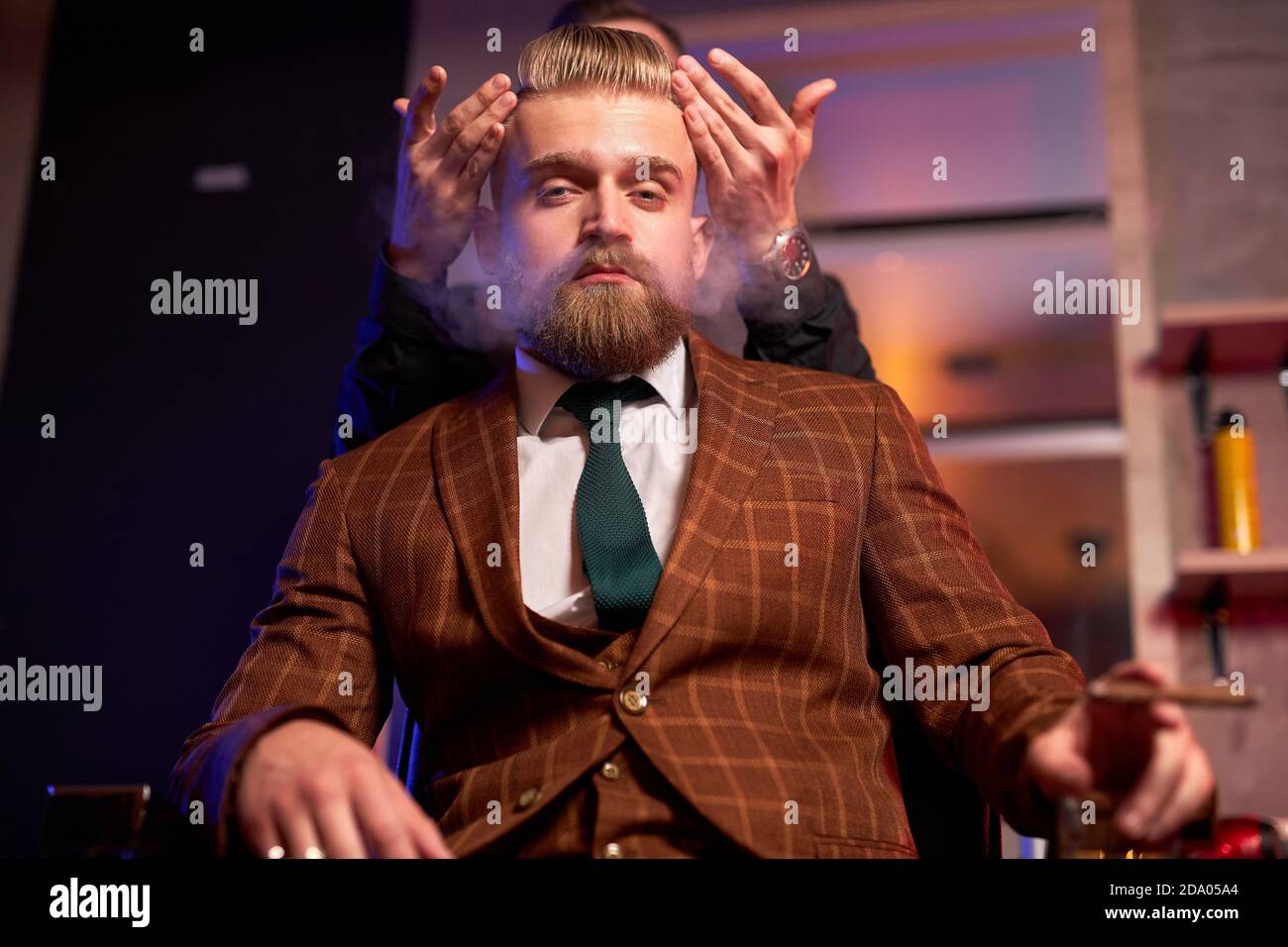 stylish male enjoy haircut at the hairdresser, he is smoking during ...