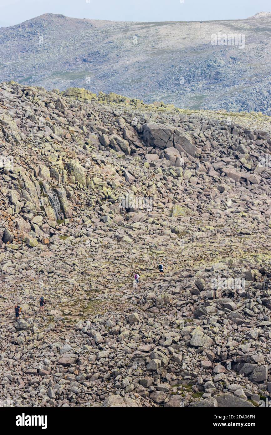 Hikers on a huge rocky ridge near the summit of Scafell Pike, England ...
