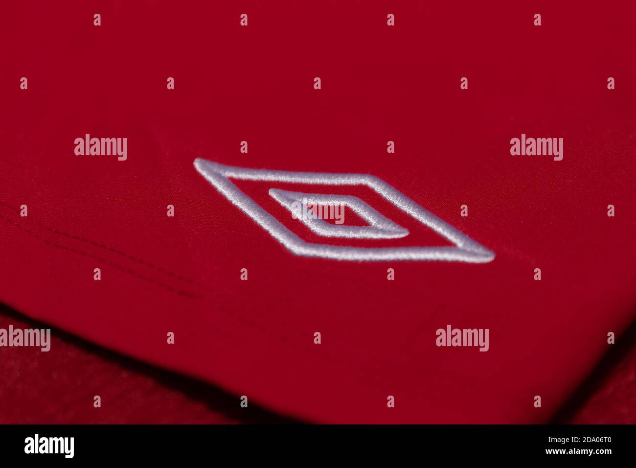Embroidered Silver White Umbro Logo on a Red football shirt Stock Photo ...