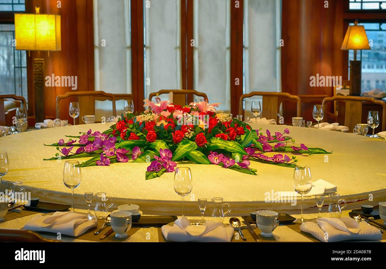 Typical in China, round table decorated with flowers prepared for ...