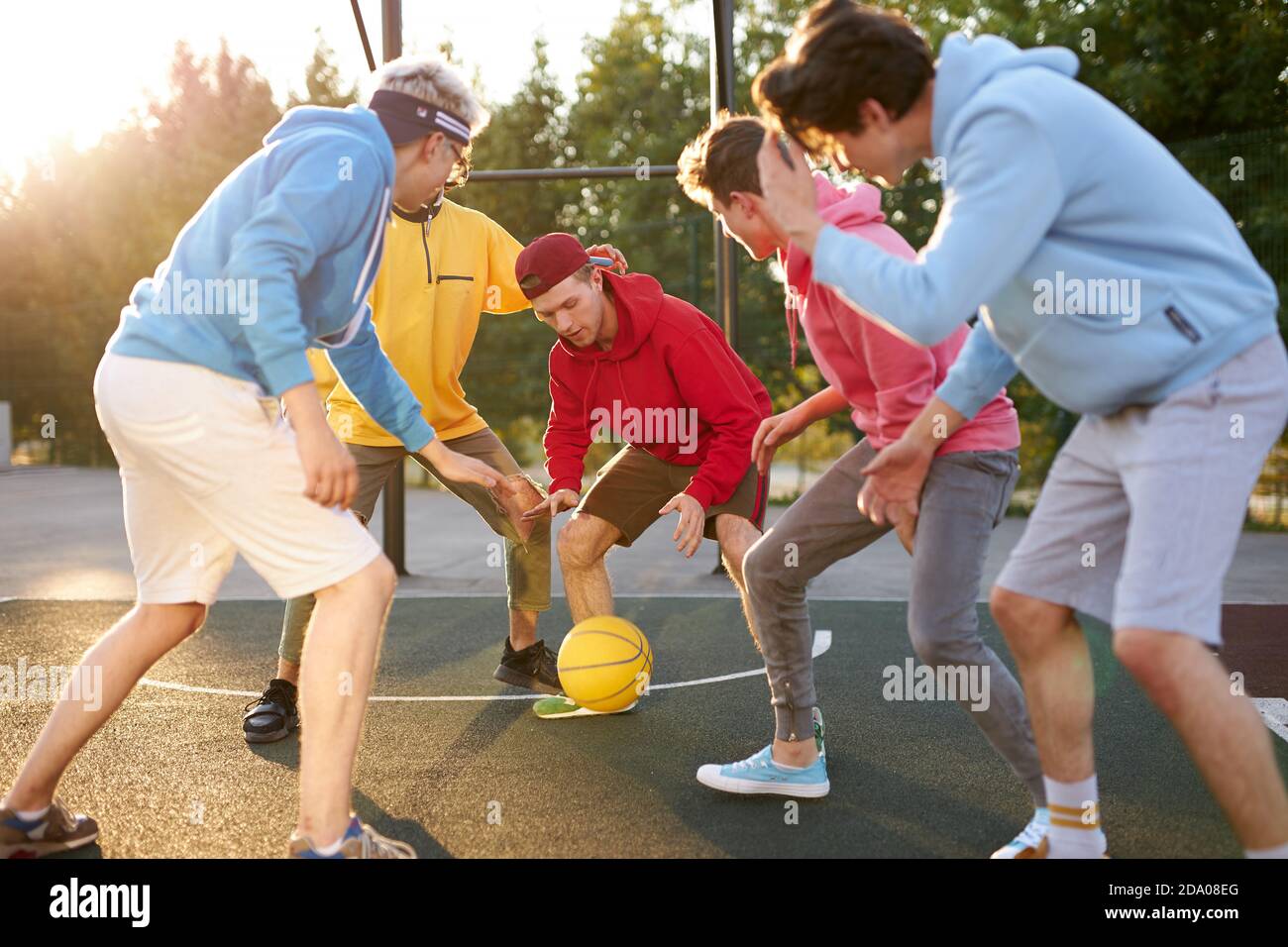 teens boys playing basketball on outdoor court, playground and having ...