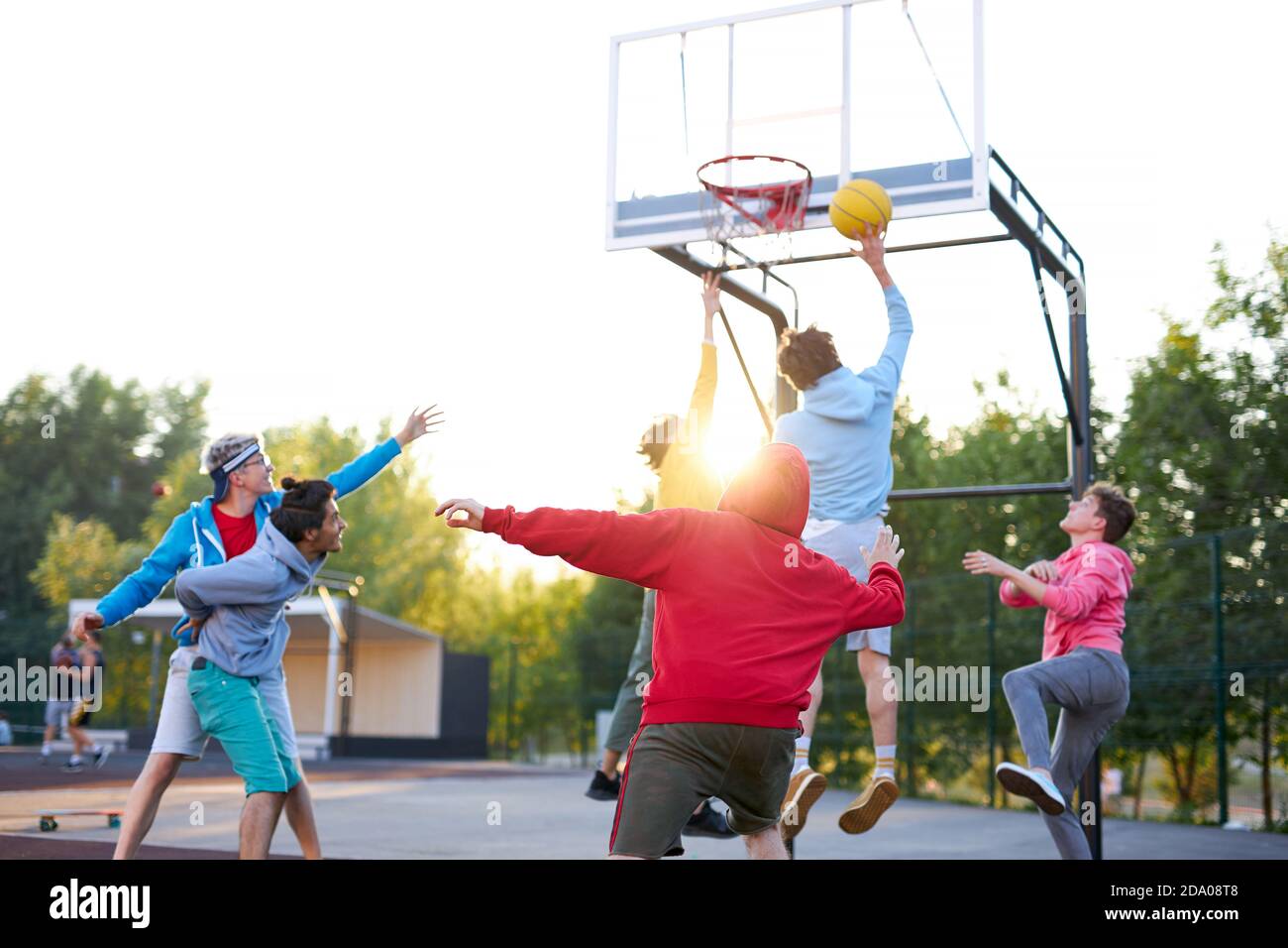 slam dunk. young caucasian basketball players, boys throwing ball into ...