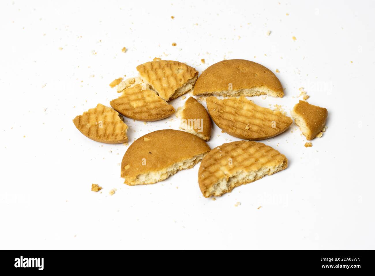 Broken wheat biscuits scattered on white background Stock Photo - Alamy