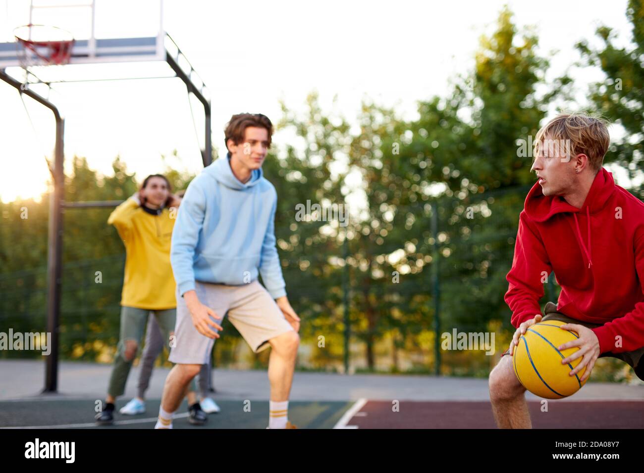 teens boys playing basketball on outdoor court, playground and having ...