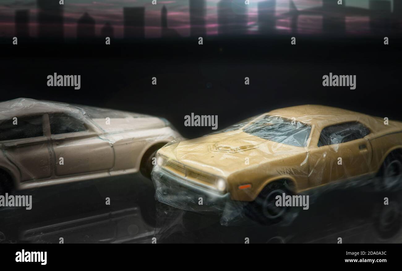 2 cars pass each other at night, they are wrapped in plastic Stock ...