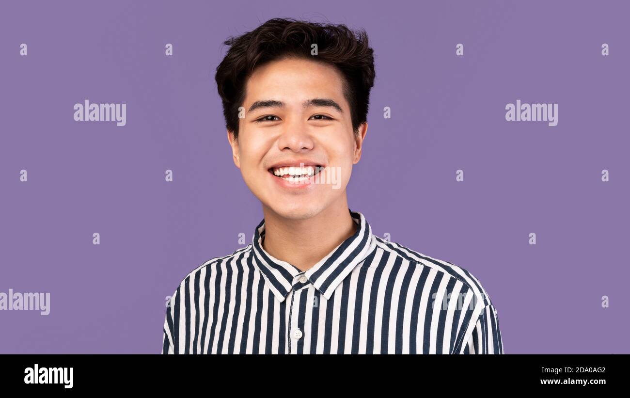 Portrait of attractive asian guy posing at studio Stock Photo - Alamy