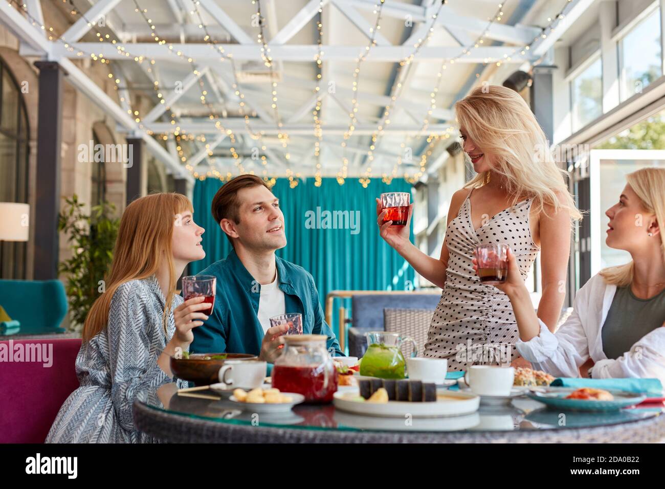 cheerful caucasian friends spending time together in bright cozy time ...