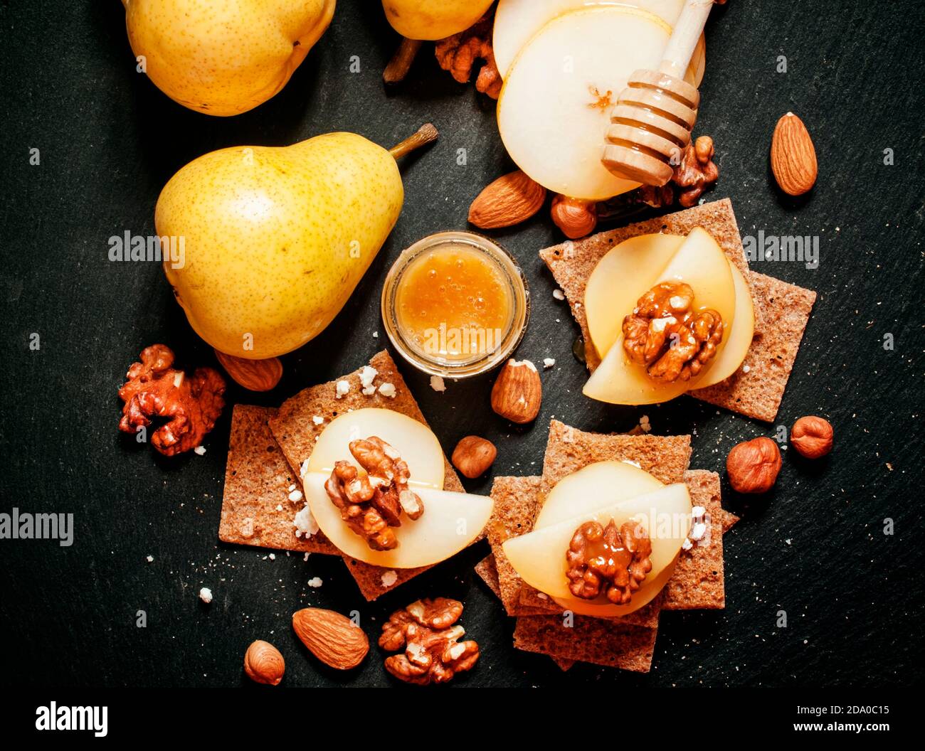 Appetizer canape with pear, honey, hazelnuts, almonds and cottage ...