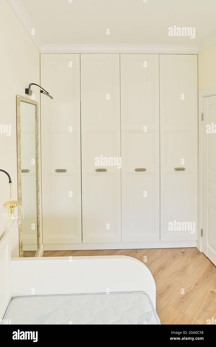 White beige pastel built-in wardrobe in the color of wall Stock Photo ...