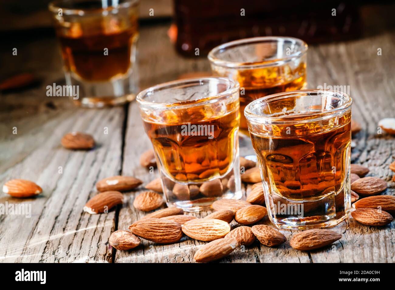 Italian amaretto liqueur with dry almonds on the old wooden background ...