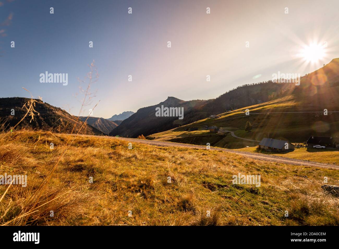 Beautiful scenic mountain scenery with huts and warm colors, sundown ...