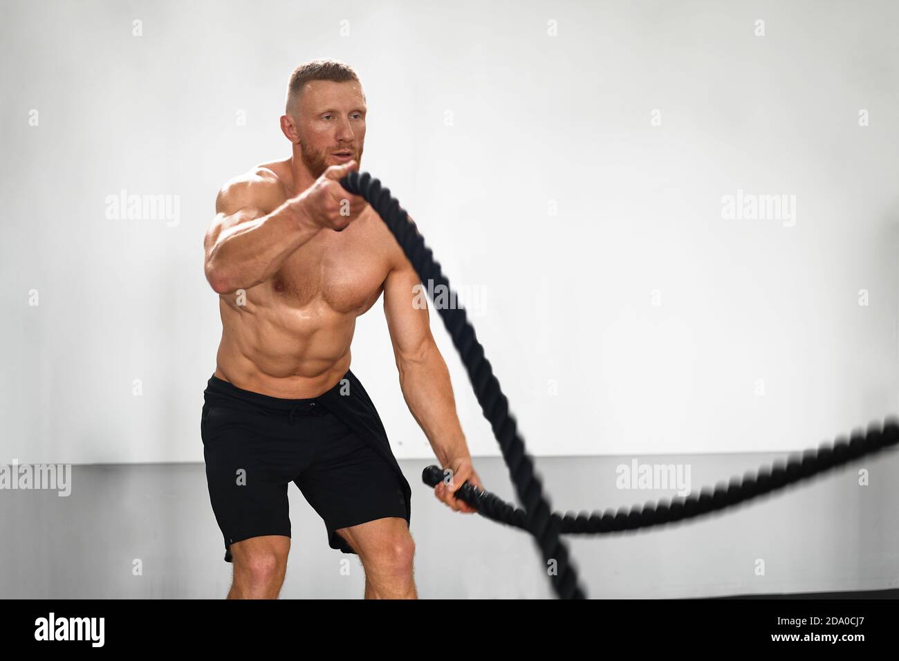 Gym battle rope man stamina training Athlete guy fitness exercising ...