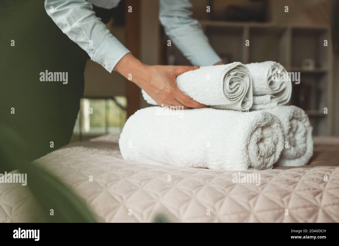Room service. Woman changing towels in hotel room Stock Photo - Alamy