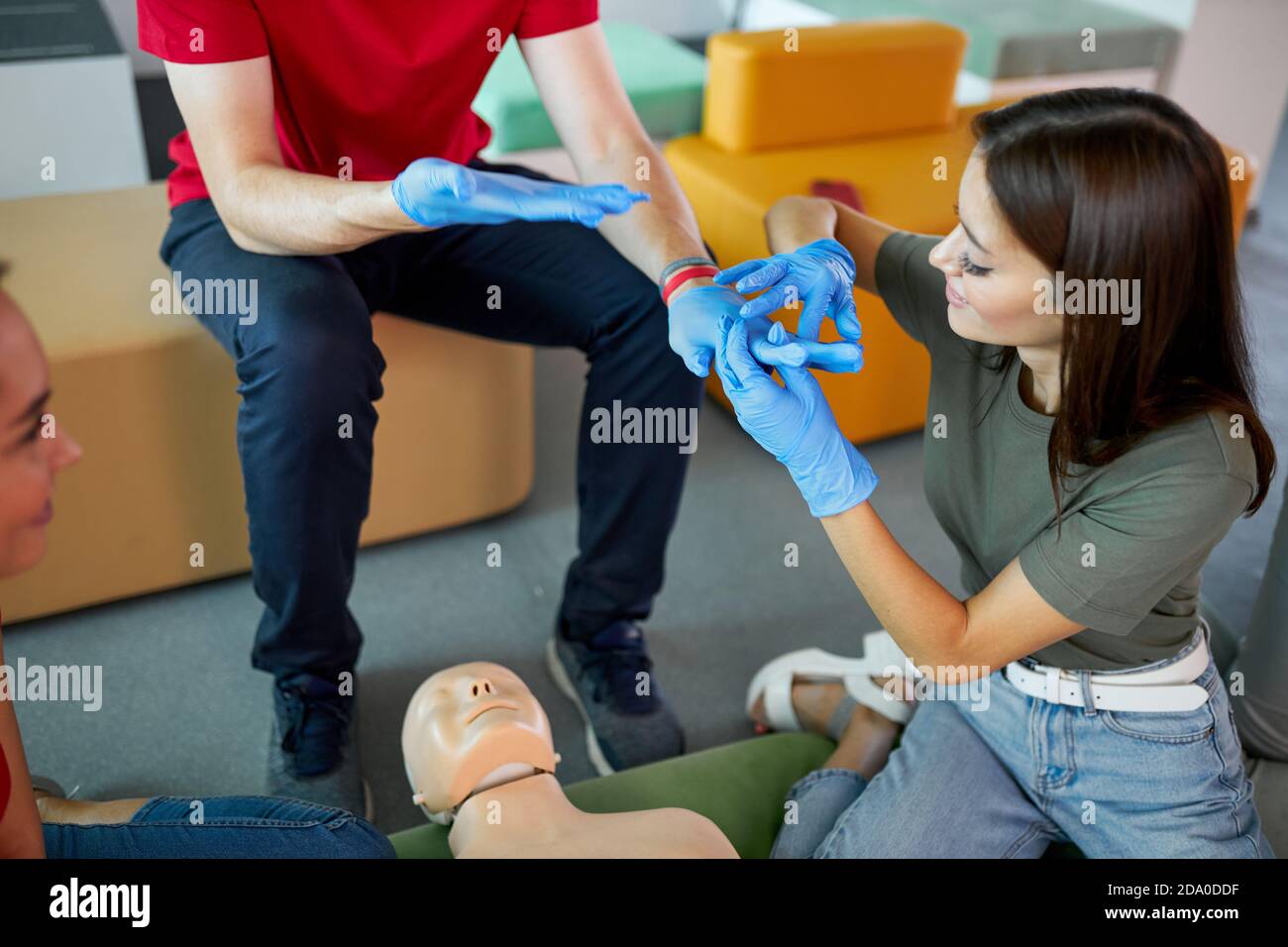 students wearing protective medical gloves before first aid class, help ...