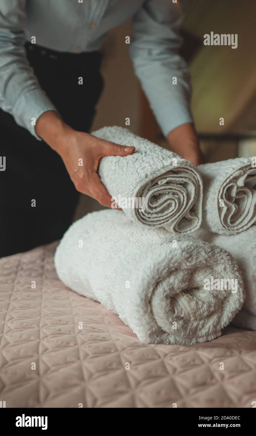 Room service. Woman changing towels in hotel room Stock Photo - Alamy