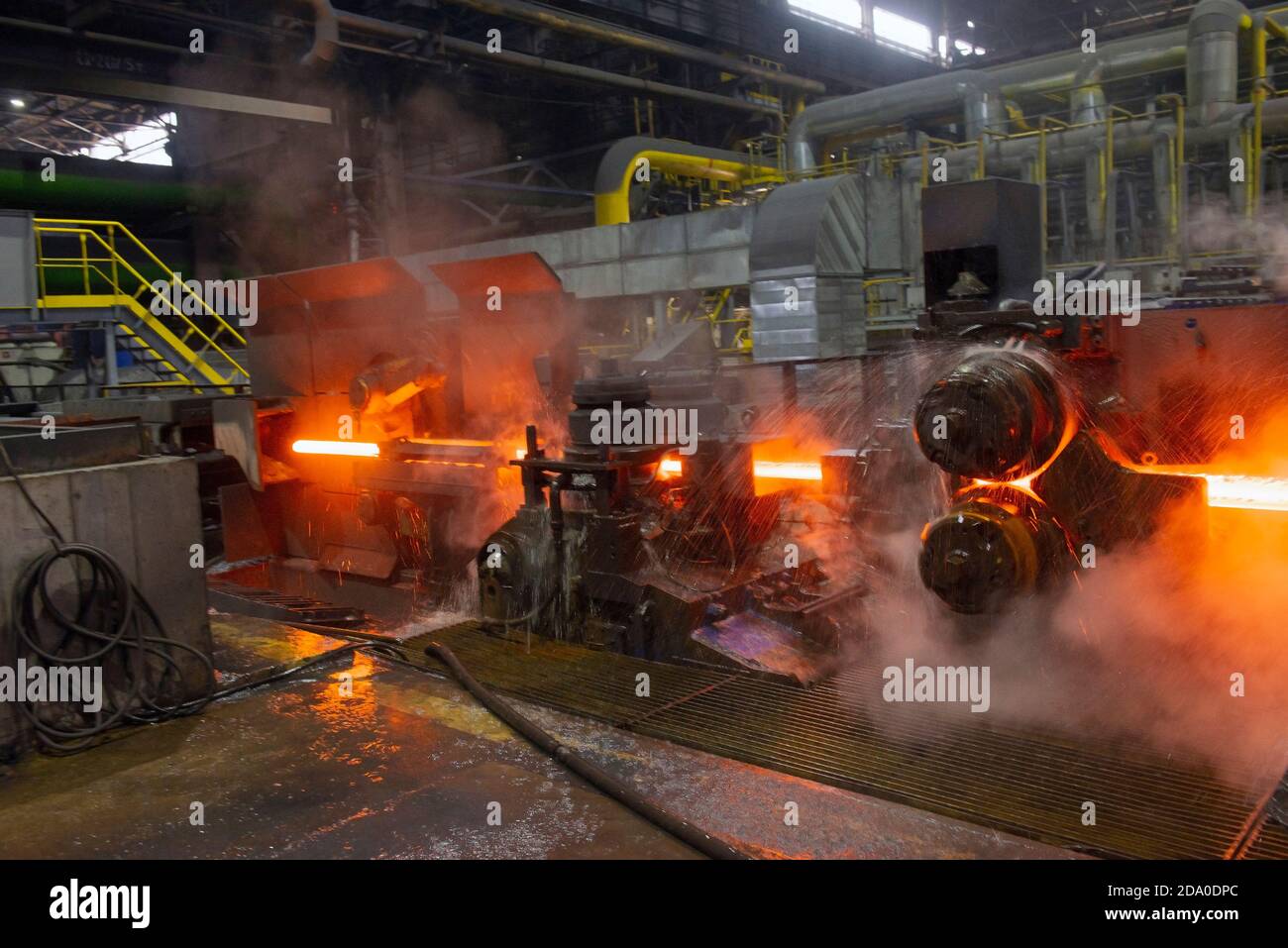 hot steel on conveyor in a steel mill. hot rolled rebar Stock Photo - Alamy
