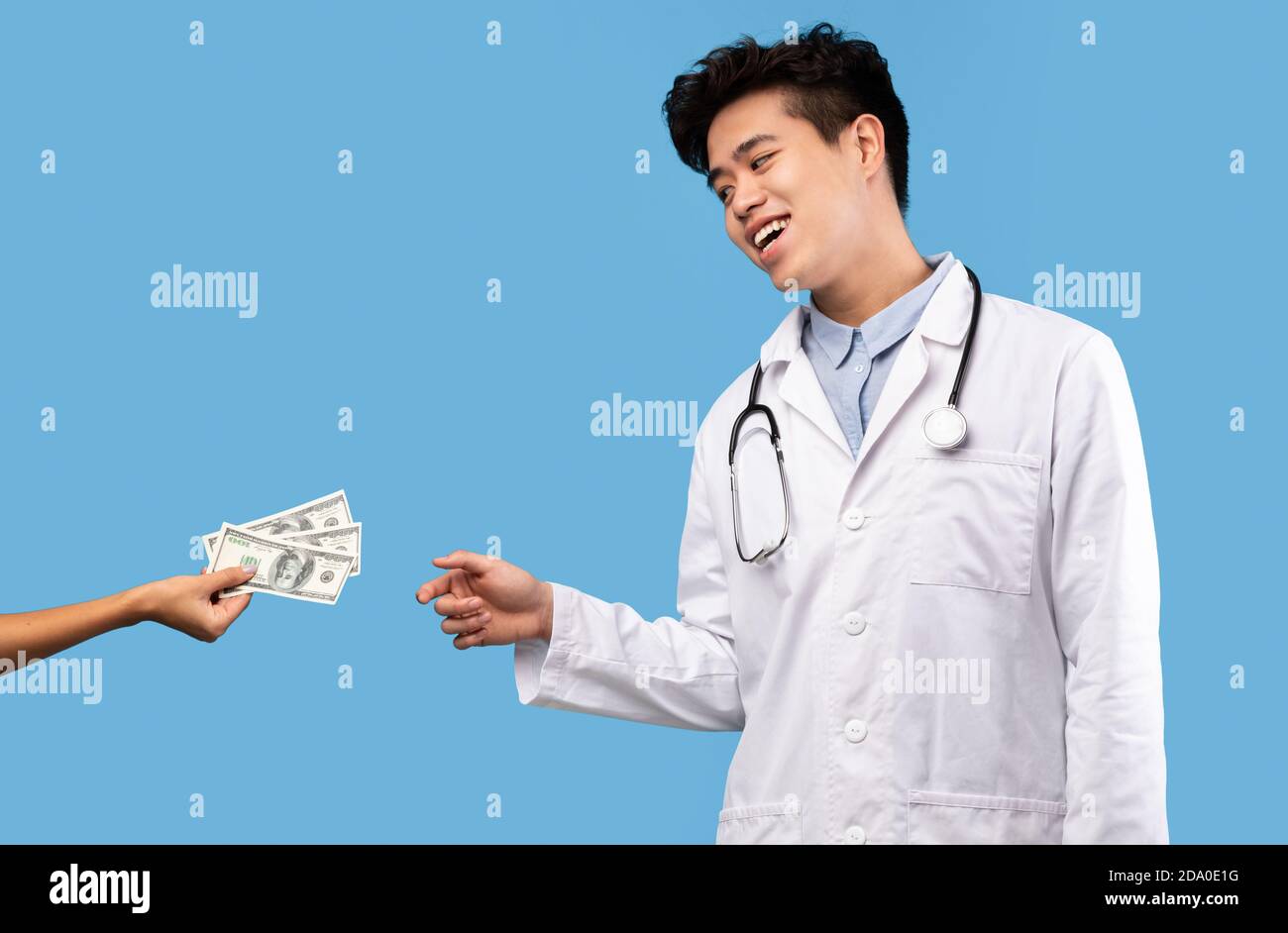 Greedy asian male doctor taking bribe from female patient Stock Photo ...