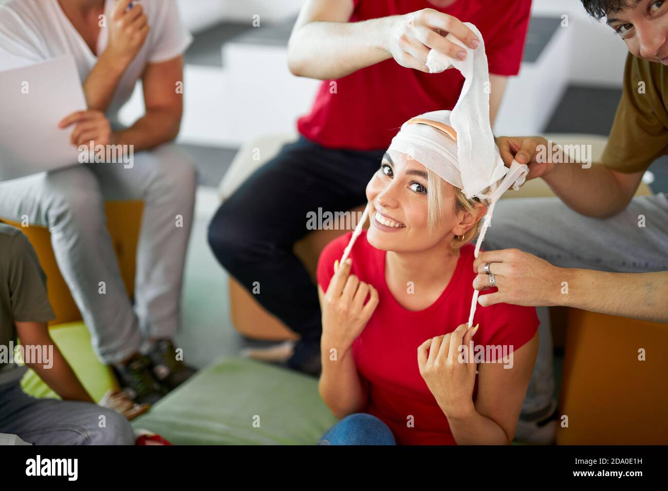 people at class of giving first aid, learn bandaging the head, sit ...