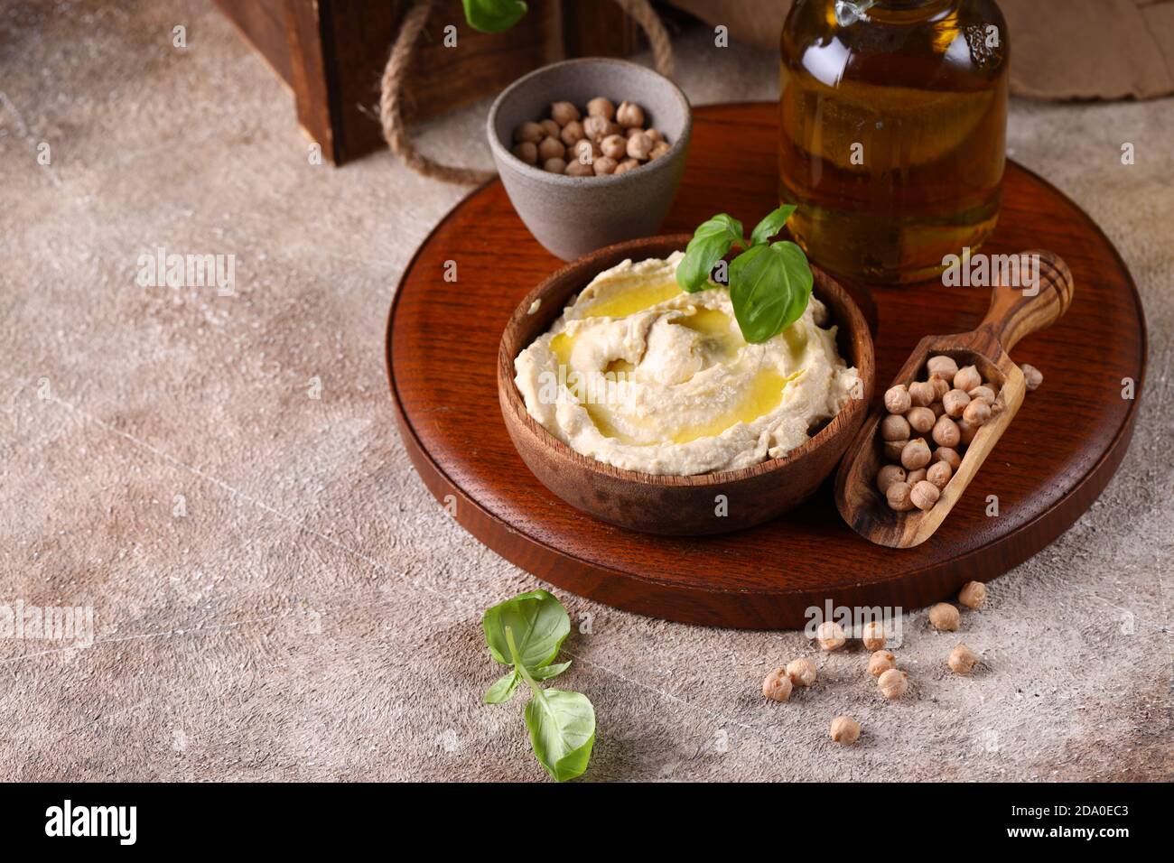 homemade chickpea hummus with olive oil and basil Stock Photo - Alamy
