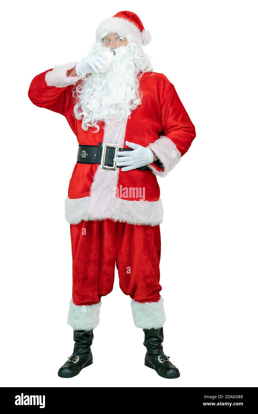Santa drinks milk. Santa Claus is drinking glass of milk on white ...