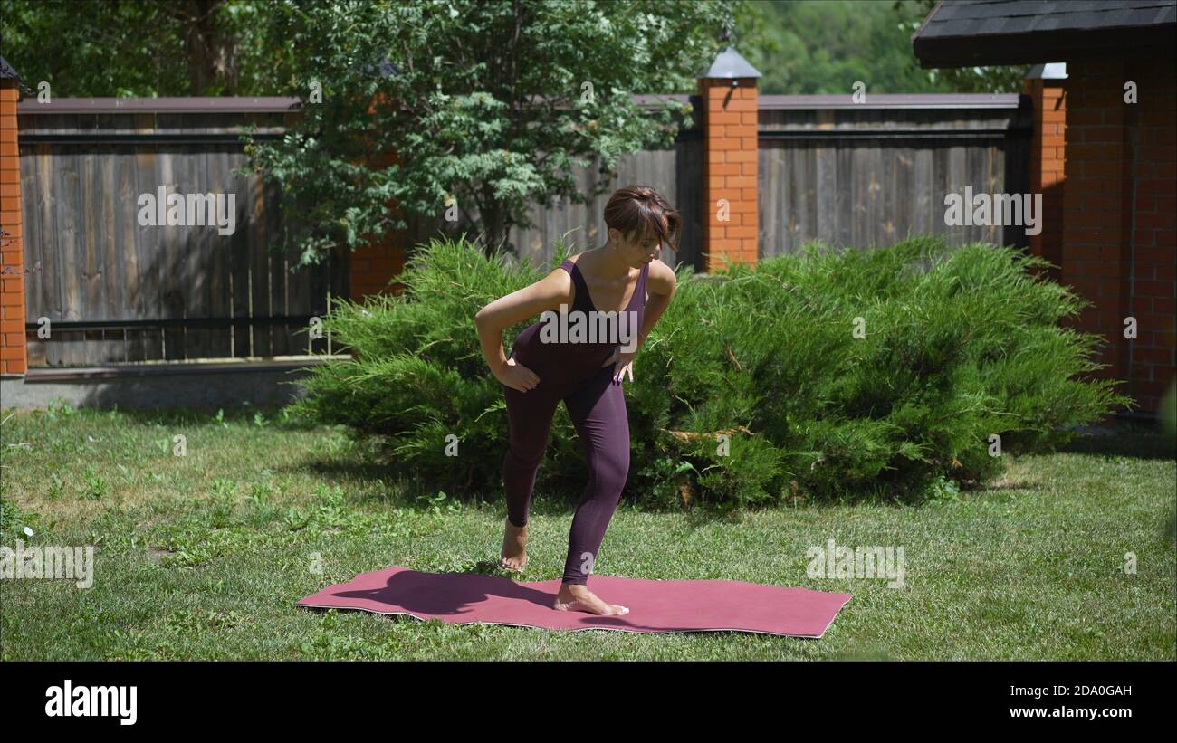 Woman doing Pilates in nature. Beautiful caucasian woman doing pilates ...