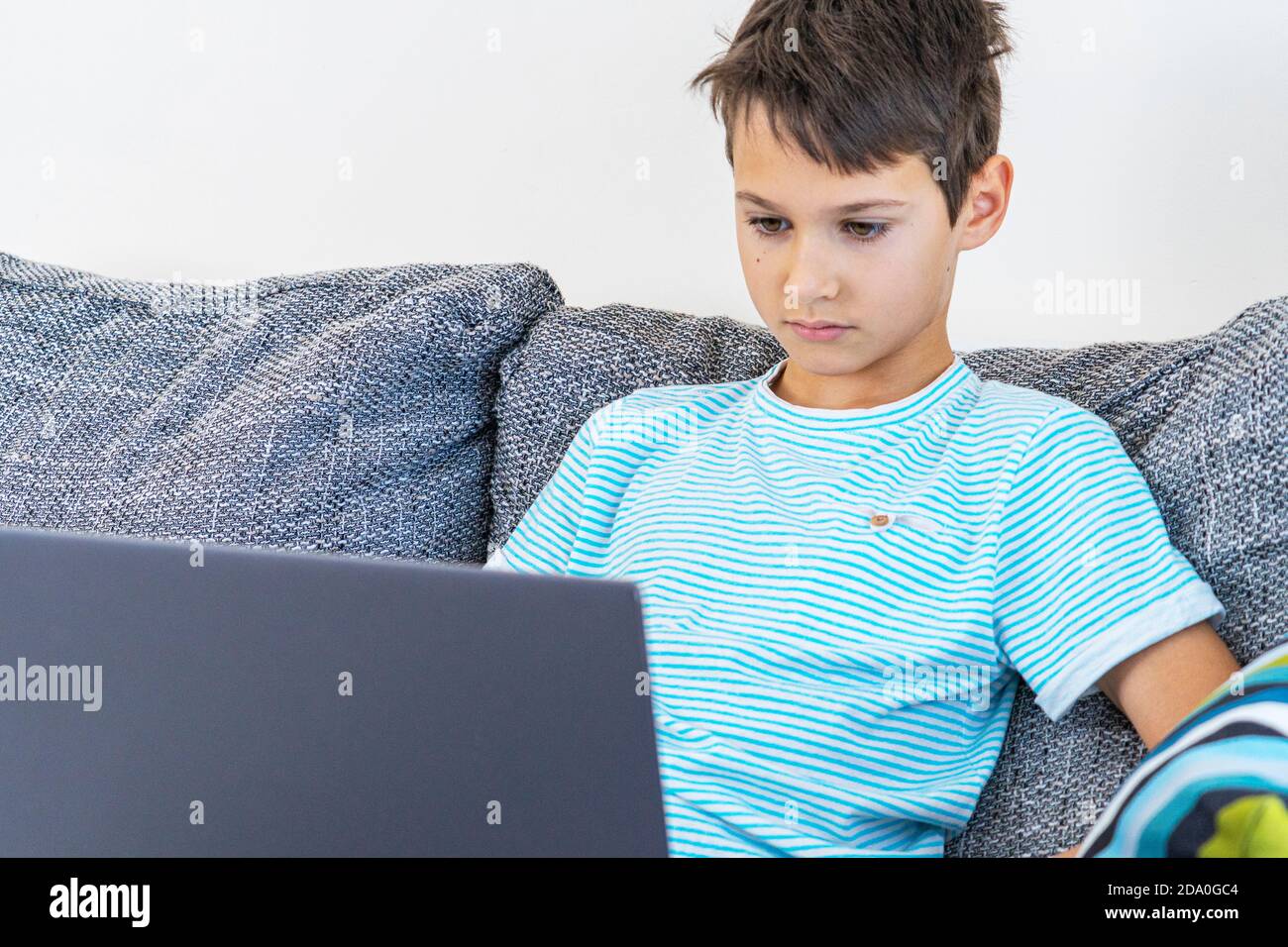 Kid using laptop computer at home. Technology, online learning ...