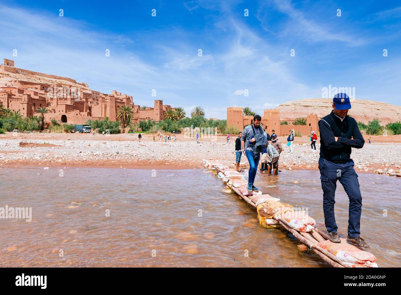 Crossing a river in rainy season. Ksar Ait Ben haddou, old Berber adobe ...