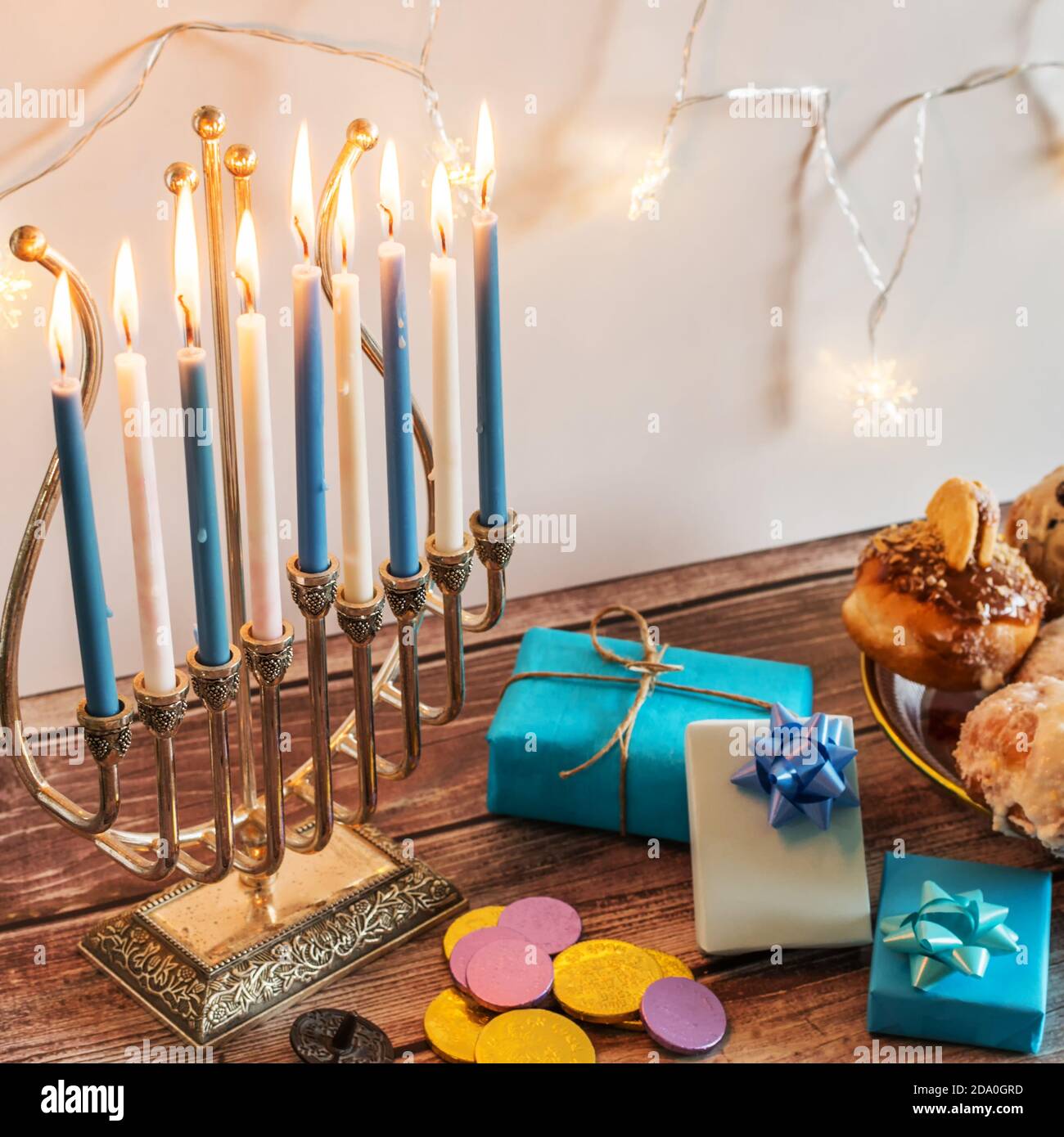 Beautiful shot of a burning Menorah lampstand next to pastry in ...