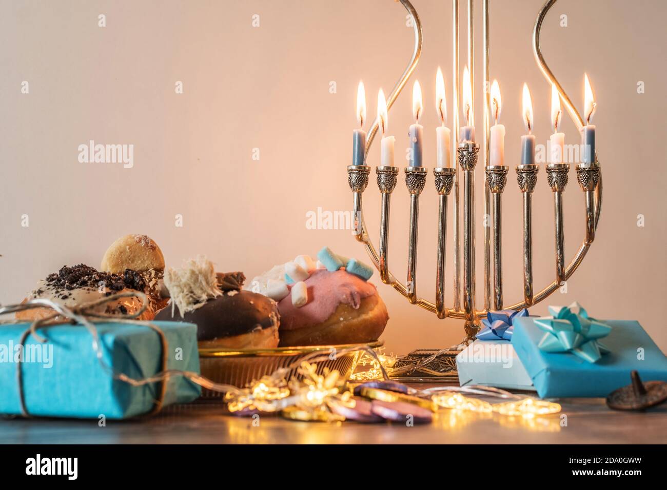 Beautiful shot of a burning Menorah lampstand next to pastry in ...