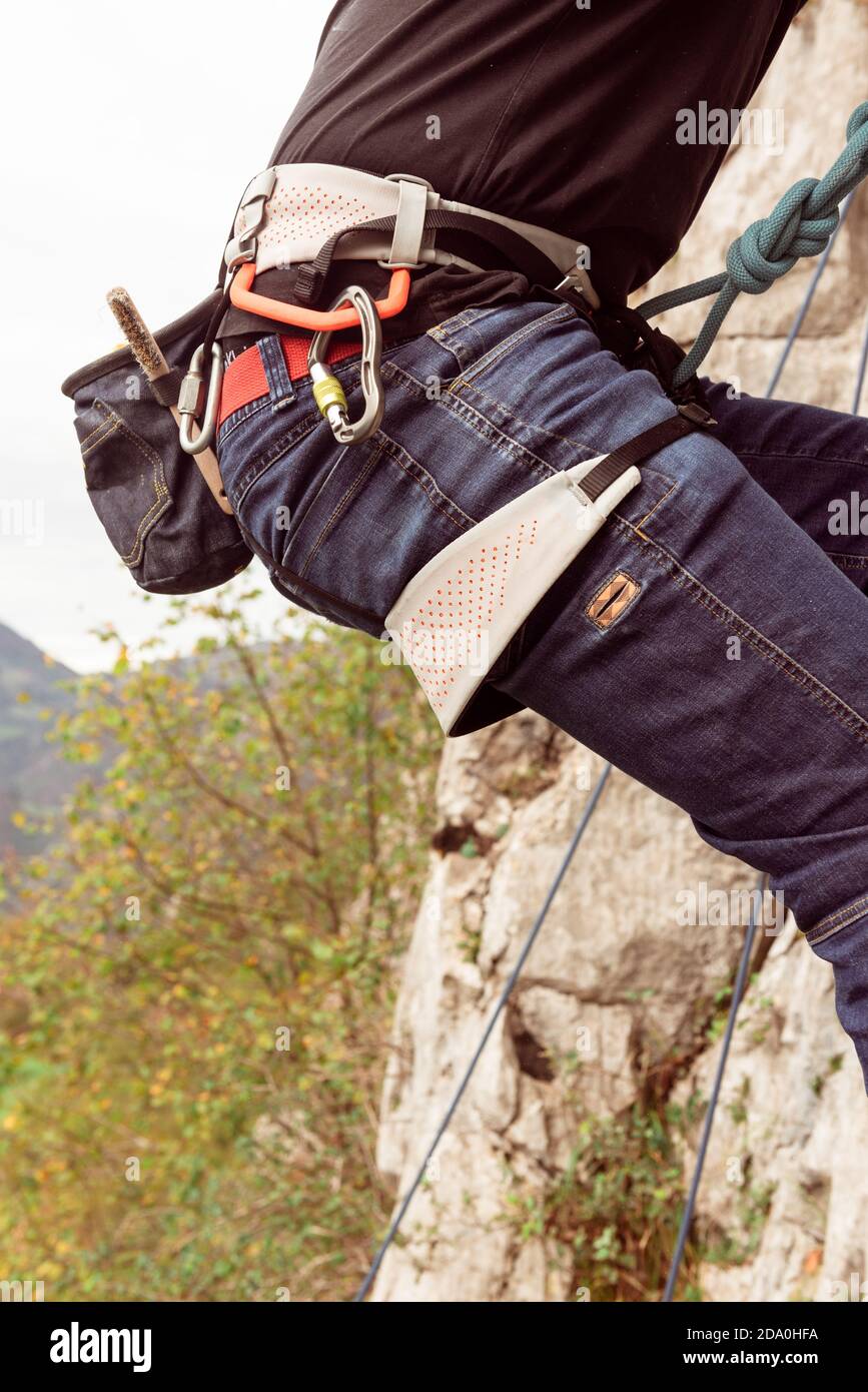 Sportive male alpinist climbing on sheer cliff in summer day Stock ...