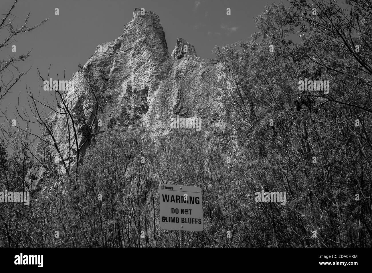 Grayscale shot of mountain with warning sign Stock Photo - Alamy