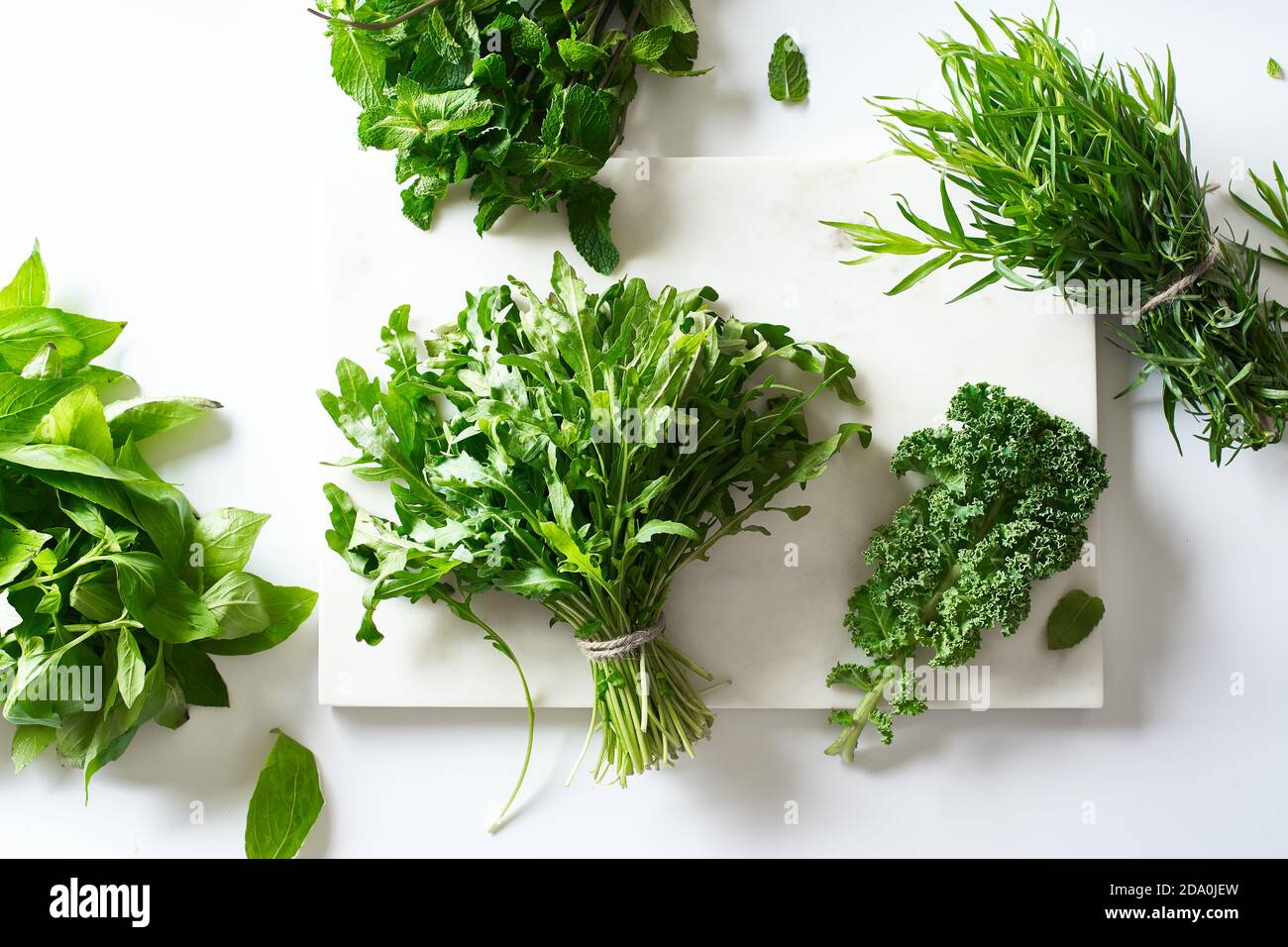 Flat lay with various herbs and lettuce and marble cutting board Stock ...