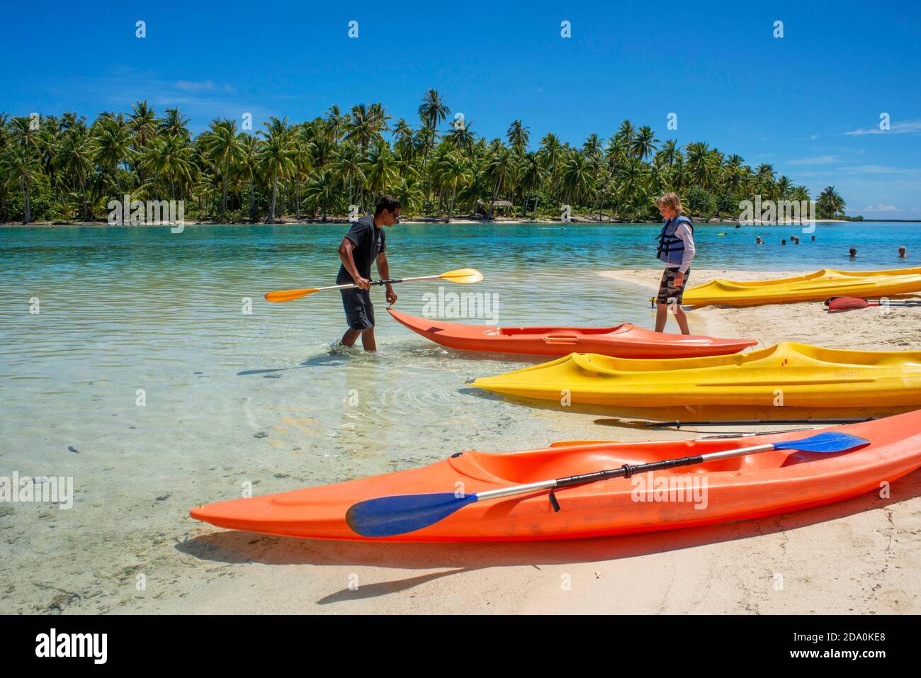 Kayaking in Taha'a island beach, French Polynesia. Motu Mahana palm ...