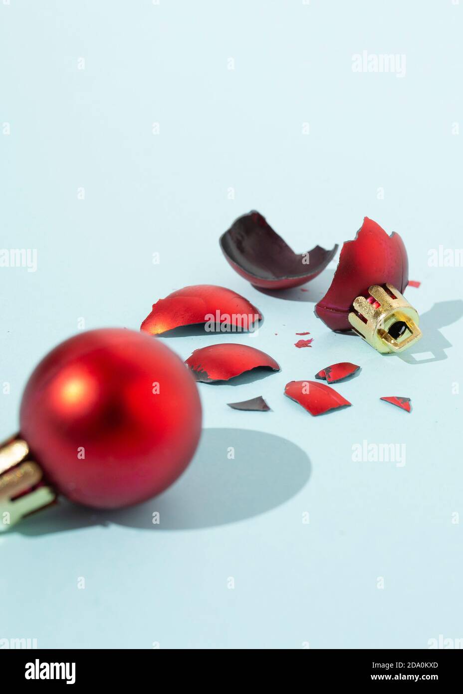 Whole and broken red Christmas balls arranged on blue background in ...
